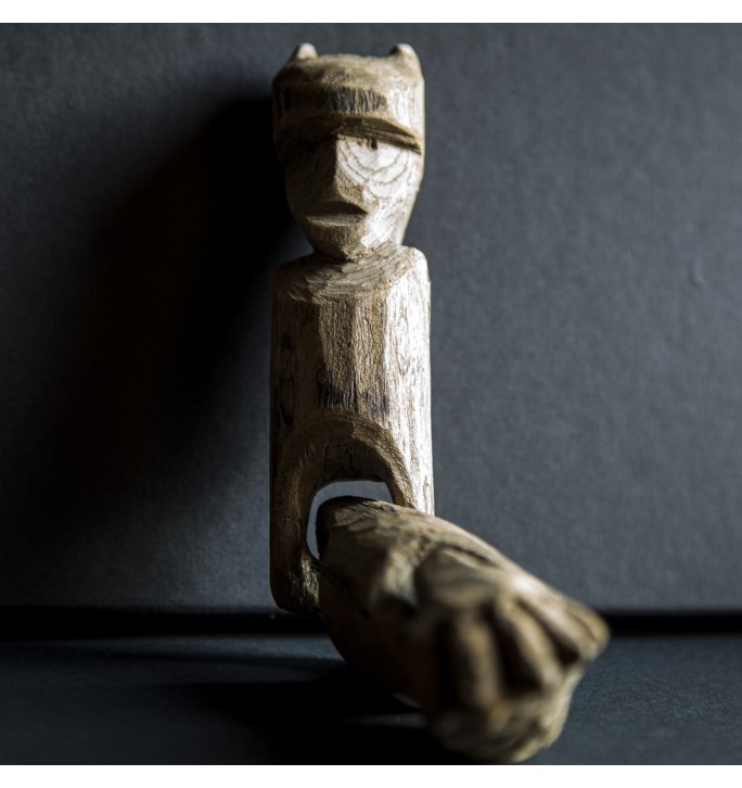 Shaman's helper idol with a bear's head and paw. Ritual wooden art.