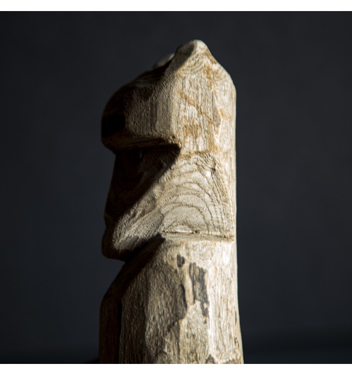 Shaman's helper idol with a bear's head and paw. Ritual wooden art.